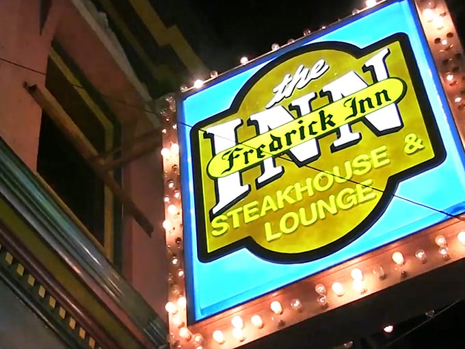 The illuminated sign glows like a beacon for hungry travelers, promising the kind of meal that will have you planning your next visit before the check arrives.