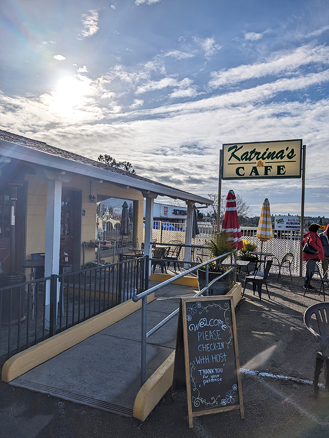 Morning light bathes the Katrina's sign in golden possibility. This isn't just a café entrance—it's the gateway to your next favorite meal.
