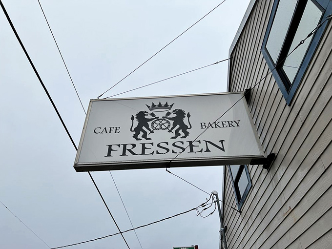 The Fressen sign proudly announces its dual identity as café and bakery—a coat of arms that promises carbohydrate royalty awaits inside.