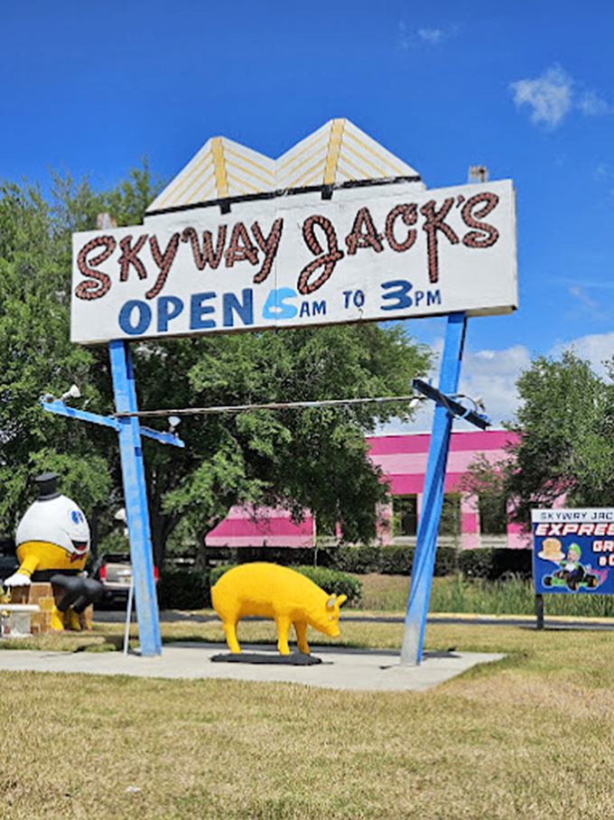 Blue sky, whimsical statues, and a sign promising early morning salvation. This roadside tableau has been beckoning hungry travelers for decades.