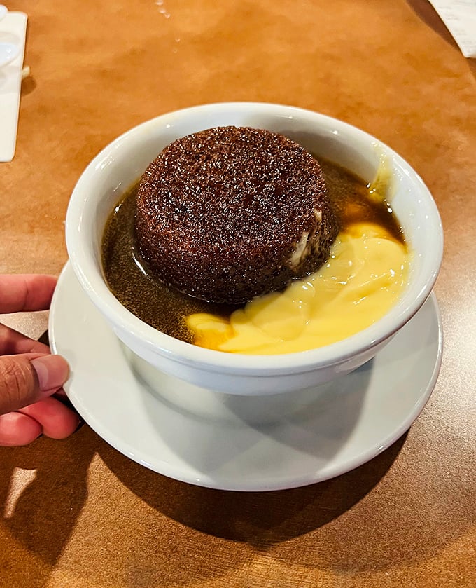 Sticky toffee pudding swimming in custard – because every great British meal deserves a proper sweet ending.