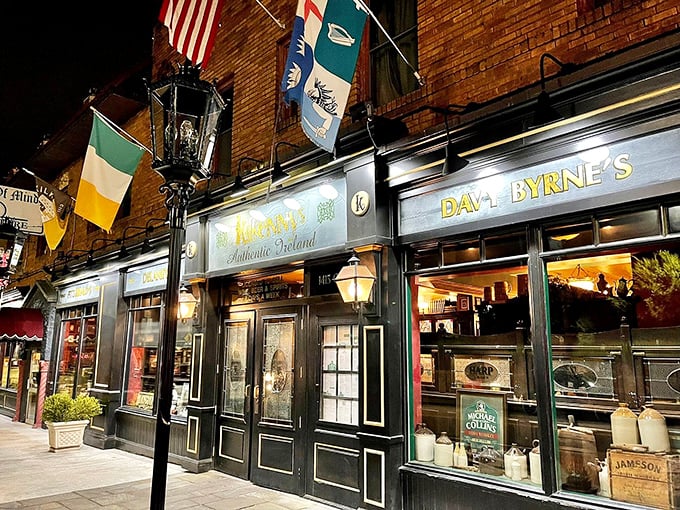 By night, the façade transforms into a beacon of conviviality, flags fluttering above like a United Nations of good times.