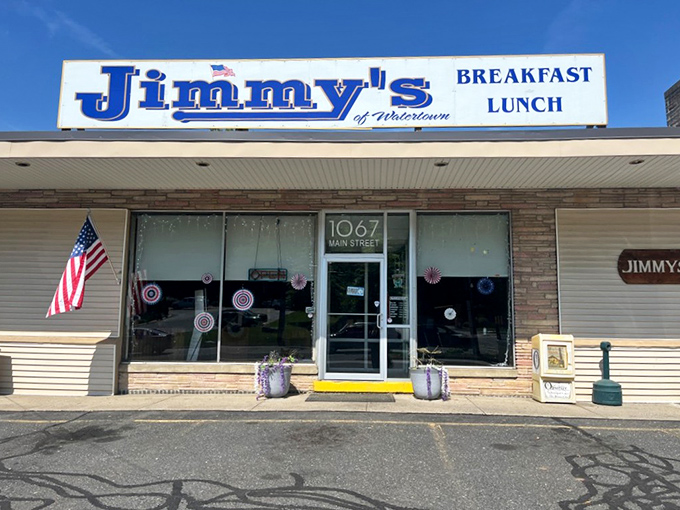 Jimmy's storefront stands ready for another day of feeding Watertown. That American flag isn't just decoration—it's a promise of classic diner tradition.