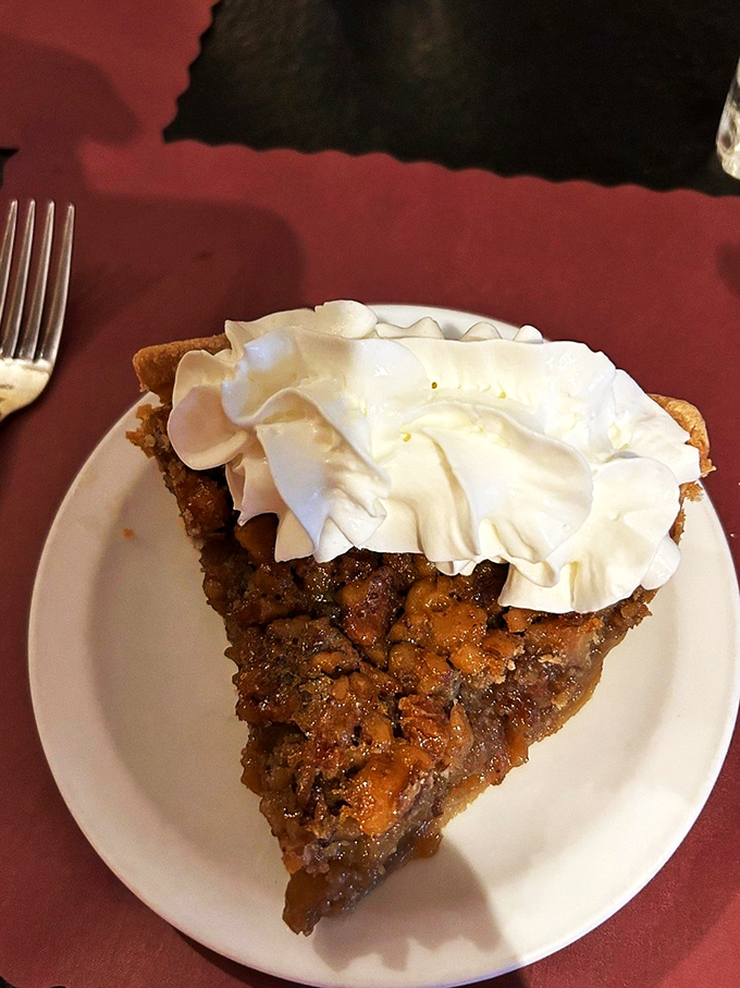 Not just walnut pie but a sweet revelation topped with clouds of whipped cream—dessert that makes you reconsider your life choices.
