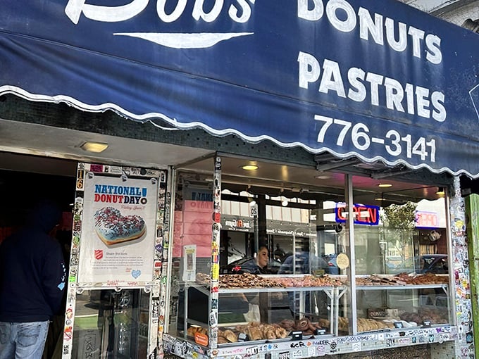 Bob's classic blue awning beckons like an old friend. Inside those windows, donut dreams come true daily.