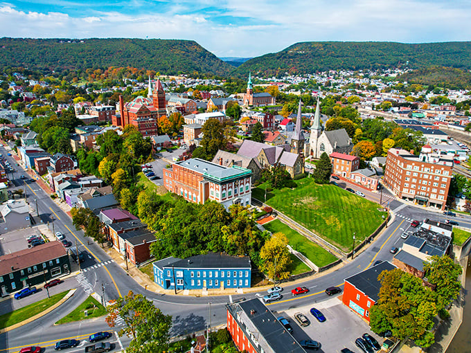 Cumberland's aerial view showcases nature's perfect embrace – mountains cradling a historic downtown like a treasure in velvet.
