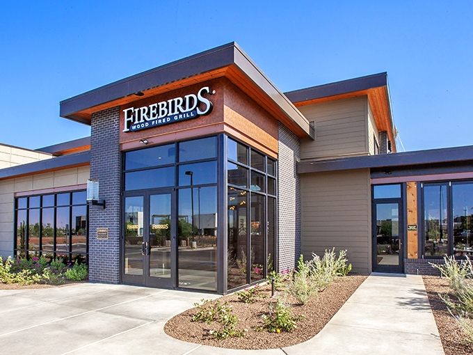 Firebirds' modern exterior promises what lies within—a temple to wood-fired perfection where steak dreams come true.