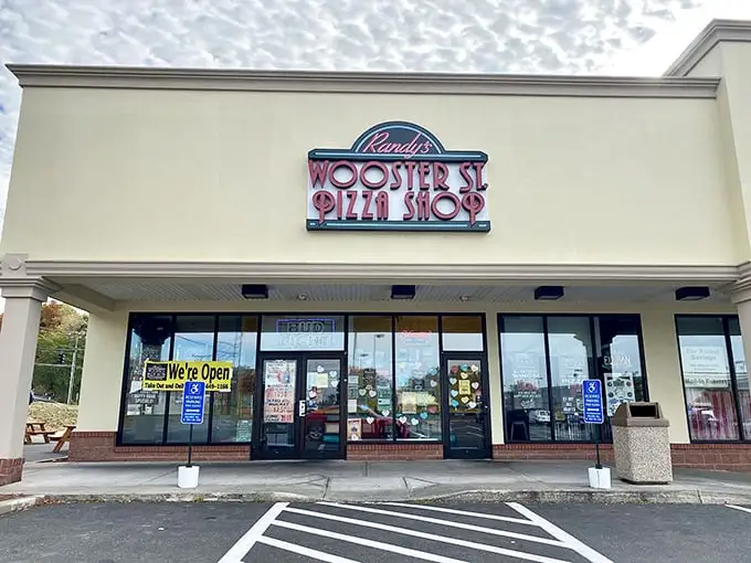 Randy's Wooster Street Pizza: That neon sign isn't just a beacon—it's a promise of pizza paradise waiting inside this Manchester strip mall gem.