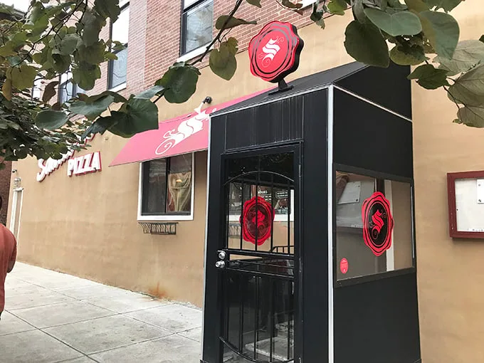 The iconic red "S" of Santucci's beckons pizza lovers like a lighthouse for the hungry. That upside-down pizza magic awaits inside!