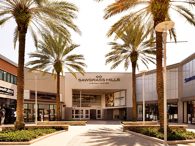 Sawgrass Mills: Palm trees stand like shopping sentinels, welcoming bargain hunters to Florida's retail paradise. Sunshine and savings await!