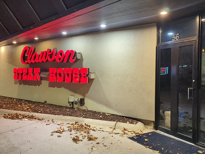 The iconic red neon sign at Clawson Steakhouse glows like a beacon for meat lovers. It's not trying to be fancy—it's promising steak paradise!