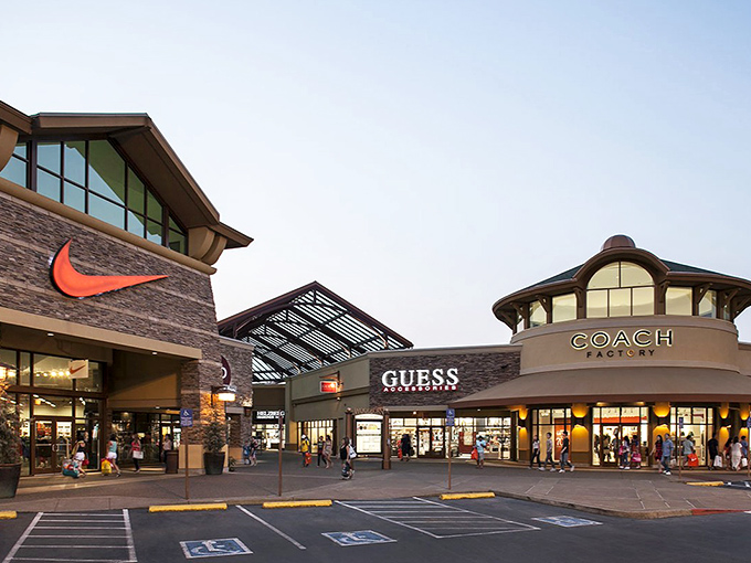 Look at those designer storefronts gleaming like jewels - Nike and Coach beckoning bargain hunters everywhere.