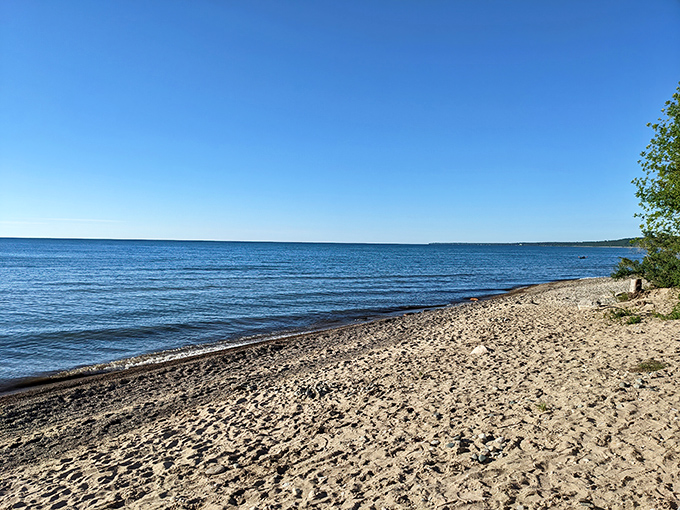 Sandy shores stretch along Lake Huron at Harrisville, where the water sparkles like nature's own diamond collection on sunny days.
