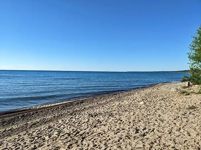 Sandy shores stretch along Lake Huron at Harrisville, where the water sparkles like nature's own diamond collection on sunny days.