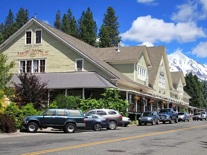 The historic McCloud Hotel stands proudly against mountain backdrops, offering small-town comfort with a side of majesty.