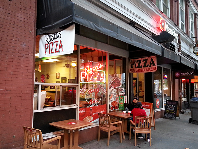 The sidewalk view of Rosa's Pizza feels like a slice of Manhattan transplanted to Georgia. That neon sign is practically whispering "get in here."
