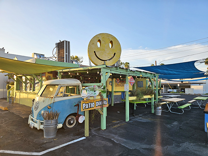 That giant smiley face isn't lying—you'll be grinning too after trying their no-frills seafood tacos on this cheerful patio.