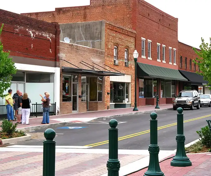 These charming green lampposts aren't just decorative—they're holding up decades of small-town conversations and friendly hellos.