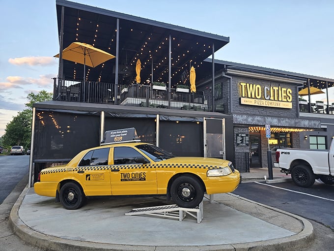 That yellow taxi isn't lost – it's announcing "New York style inside!" while the rooftop patio whispers "stay awhile" under twinkling lights.