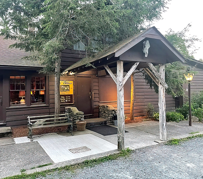 Step into a storybook at twilight – the Walpack Inn's entrance glows with warmth, beckoning hungry travelers with its woodland magic.