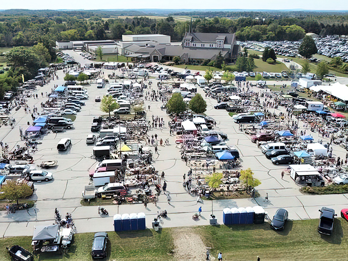 From above, the market transforms into a human chess board of vendors and visitors, each making strategic moves toward their next great find.