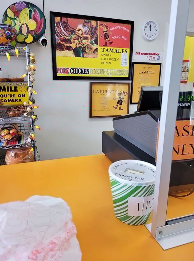The counter where dreams come true. That tip jar has funded countless food pilgrimages—each dollar a thank you note for tamale perfection.