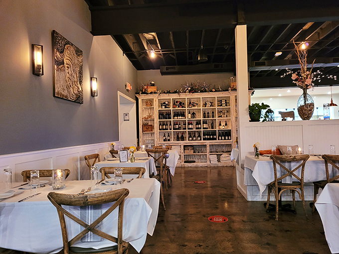 Crisp white tablecloths meet rustic cross-back chairs in this dining room that whispers "special occasion" without shouting "stuffy formality."