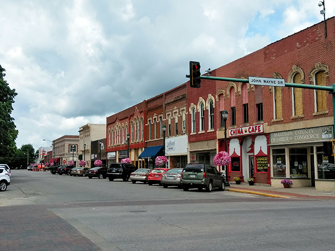 John Wayne Drive meets small-town charm where the China Cafe and Chamber of Commerce stand as sentinels of Winterset's enduring community spirit.