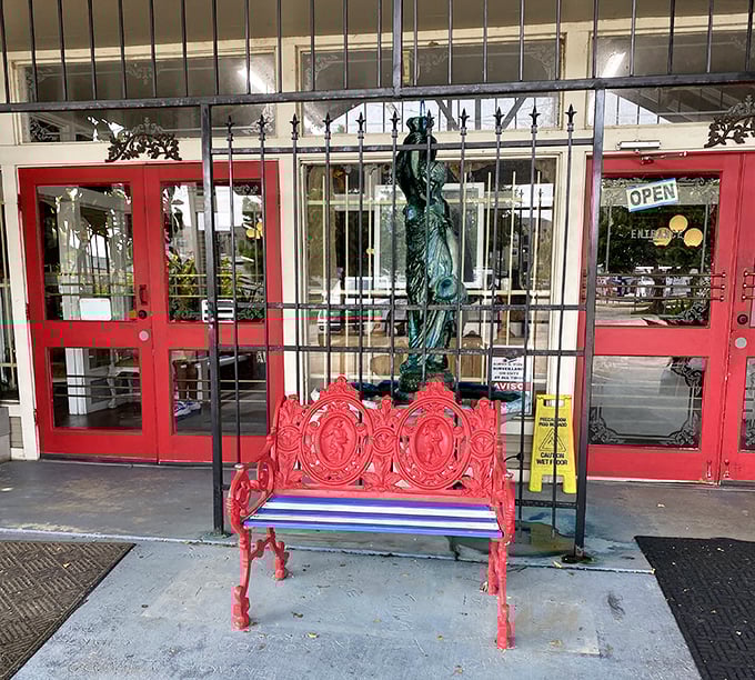 That red bench isn't just seating – it's your first clue that this place understands the perfect marriage between preservation and personality. Lady Liberty approves!