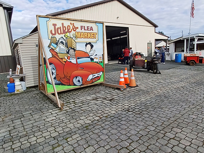The whimsical entrance sign featuring a cartoon-loaded vintage truck perfectly captures the spirit of Jake's—a place where nostalgia comes packed in cardboard boxes.