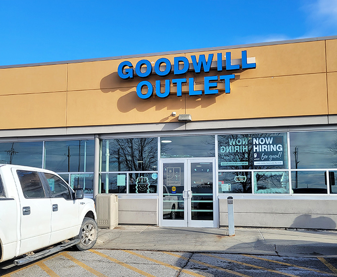 The bright blue Goodwill Outlet sign serves as a beacon for bargain hunters—a modern-day "X marks the spot" for thrift adventurers ready to dig.