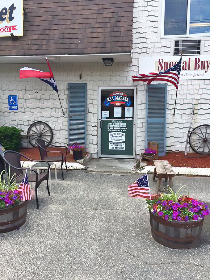 The unassuming entrance belies what awaits inside—flower barrels, wagon wheels, and flags offering a warm Massachusetts welcome.