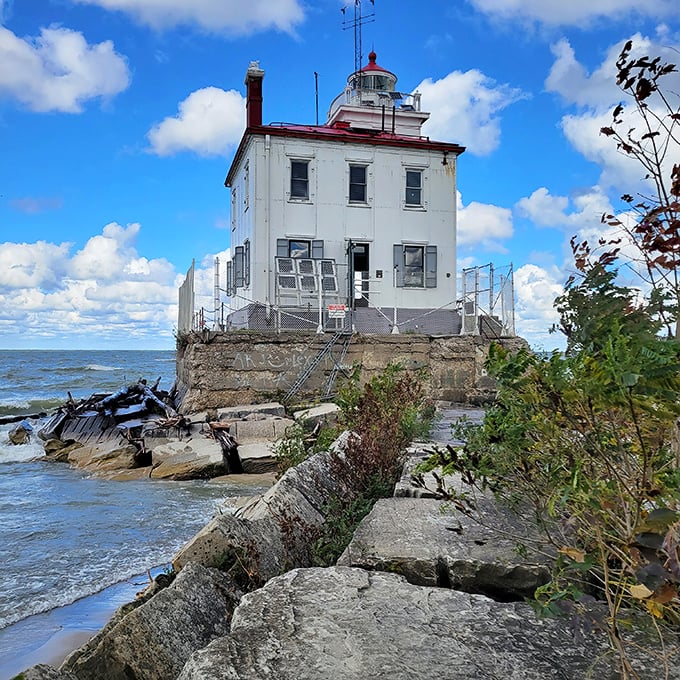 The lighthouse up close reveals its personality—weathered but dignified, like a retired sea captain still keeping watch over his beloved waters.
