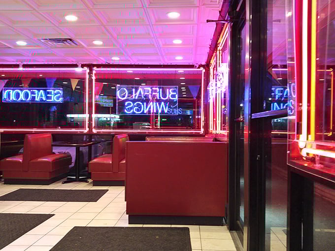 Red booths bathed in neon glow create a diner-like warmth where conversations flow as freely as the maple syrup for your waffles.