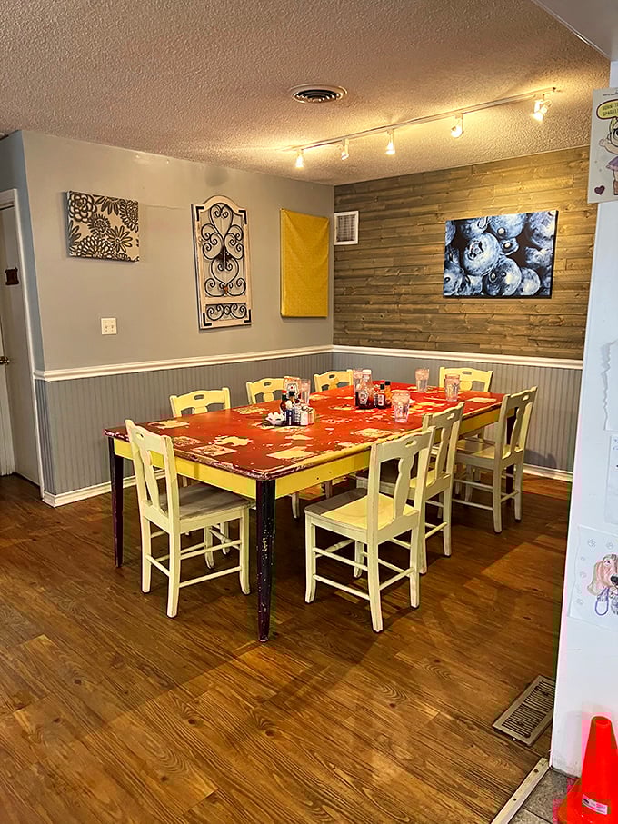 Sunshine yellow chairs pop against rustic wood floors, creating that perfect "grandma's kitchen got a makeover" vibe that makes you want to settle in for the morning.