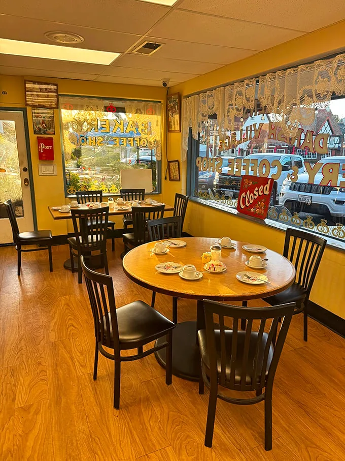 Simple wooden tables and lace curtains create that quintessential Danish hygge feeling. The perfect spot to contemplate life's big question: "Should I order one pastry or five?"