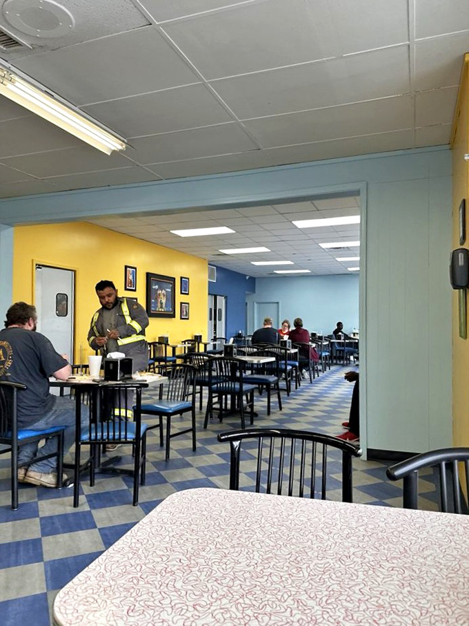 Blue and yellow walls create a cheerful backdrop for serious breakfast business. The checkerboard floor has witnessed countless coffee refills and "pass the syrup" moments.