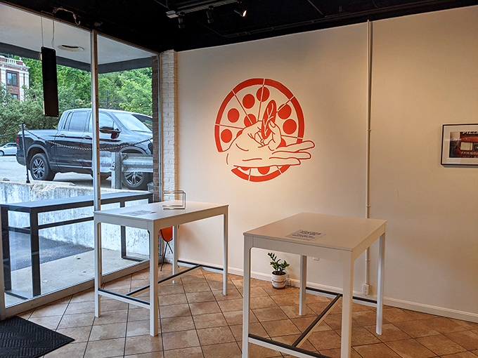 Minimalism meets pizza perfection. The clean interior with its playful logo wall art lets you focus on what matters—the impending flavor explosion.