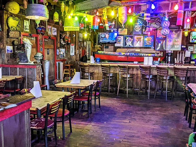 Step inside and you're greeted by a kaleidoscope of colorful string lights, weathered wood, and nautical treasures—like a pirate's hideout that serves hushpuppies.