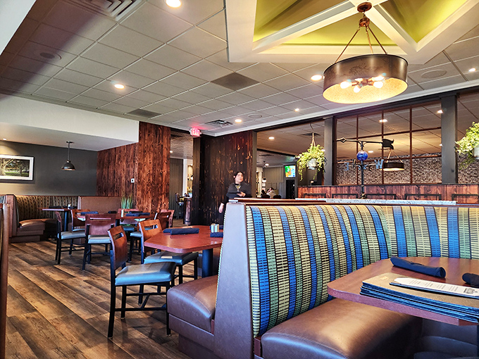 Warm wood tones and colorful booth seating create an atmosphere that says "relax, you're about to experience something wonderful."