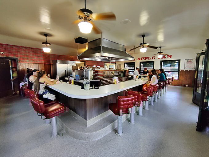 Step inside and you're transported to mid-century America – red vinyl stools, horseshoe counter, and not a smartphone charging station in sight. This isn't retro by design; it's authentic by survival.