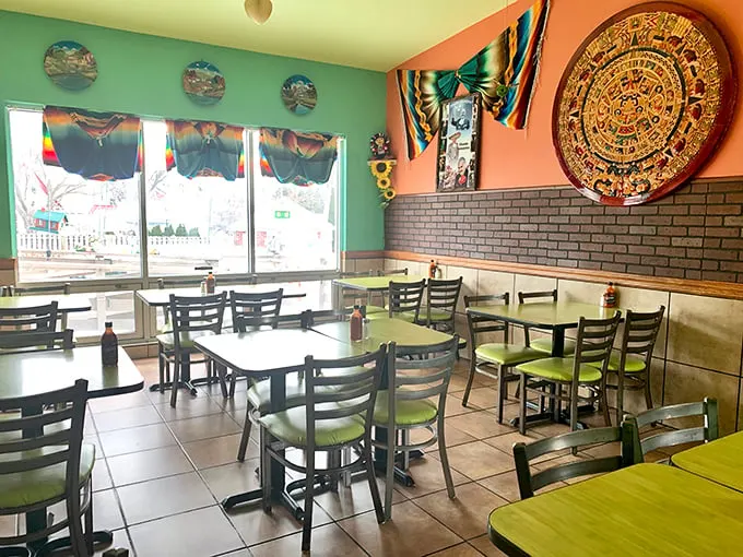 Mint green walls meet salmon pink, with that magnificent Aztec calendar watching over diners like a guardian of authentic flavors. No Instagram staging here – just real atmosphere.