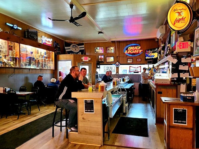 Wood paneling, neon beer signs, and ceiling fans spinning lazily overhead—this isn't just a tavern, it's a time machine to simpler, more delicious days.