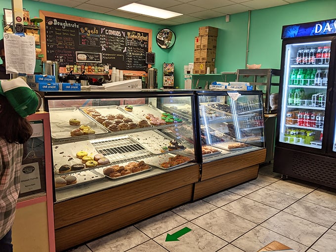 Step inside and behold the promised land – display cases brimming with handcrafted delights against cheerful mint-green walls that say "happiness served daily."