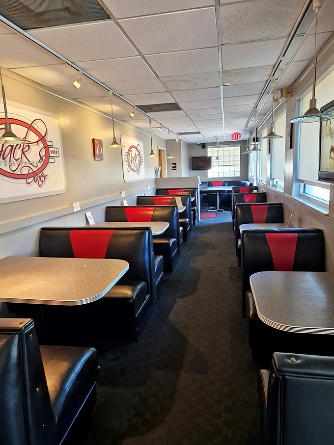 Classic black and red vinyl booths invite you to slide in and stay awhile – each one a front-row seat to the timeless theater of diner life.