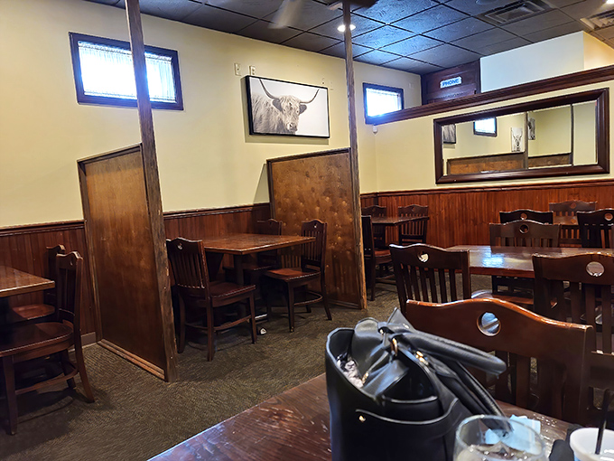Cozy wooden booths create intimate dining spaces while Highland cattle artwork watches over your meal. The perfect blend of rustic charm and steakhouse sophistication.