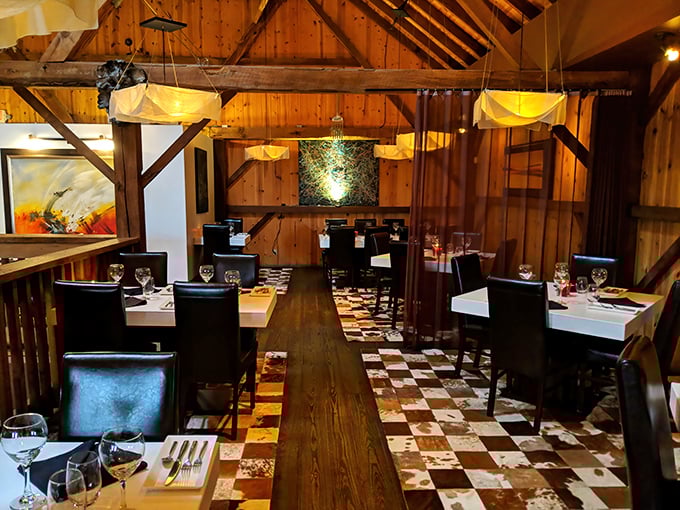 Exposed beams and checkerboard floors tell you this isn't your grandfather's steakhouse. The preserved barn architecture creates an atmosphere both upscale and unpretentious. 