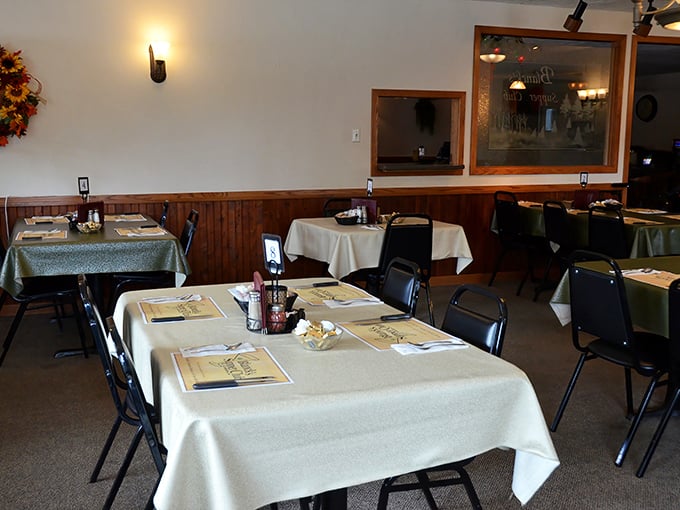 Classic Wisconsin supper club ambiance with wood-paneled walls and white tablecloths – comfort and tradition served alongside every meal.