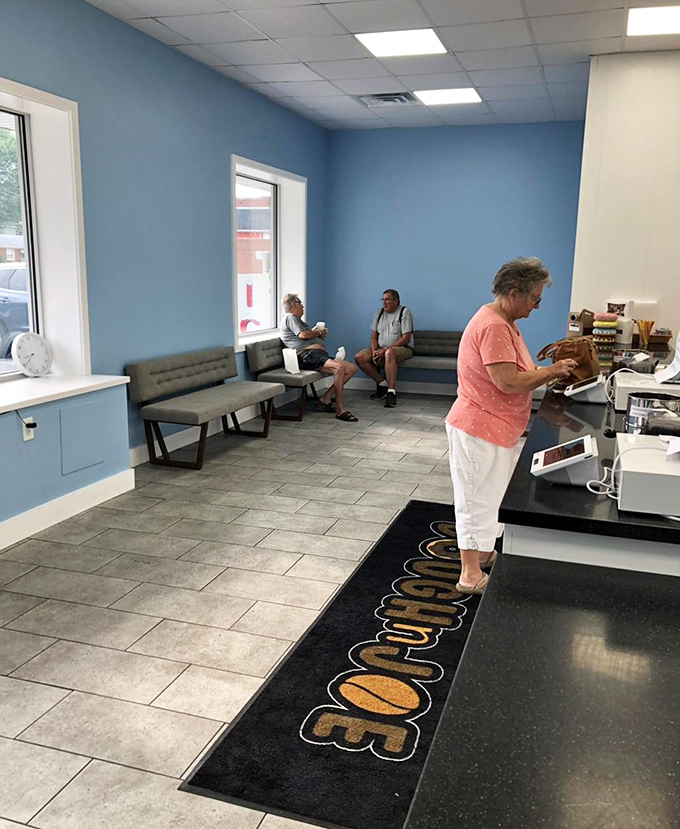 Inside, calming blue walls and minimalist seating create the perfect backdrop for the main event—donuts that deserve your full, undivided attention.
