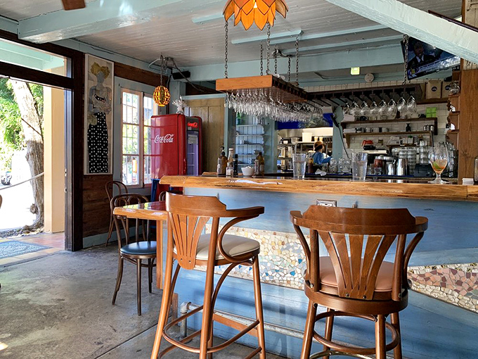 Pull up a stool at the rustic bar where Hemingway's ghost might approve of your morning mimosa choice. The hanging glassware catches light like tropical jewels.